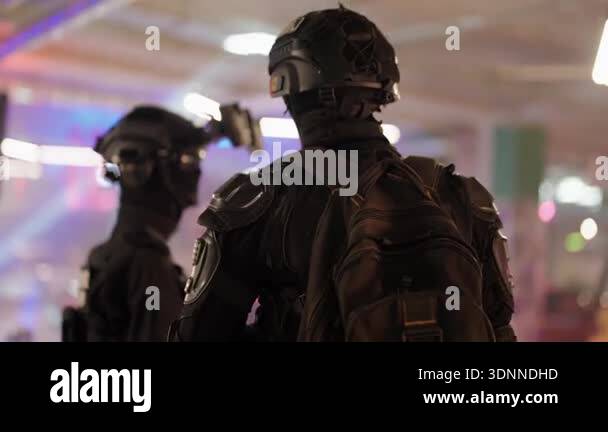 Two special forces soldiers in full tactical gear patrolling a ...