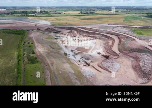 Extensive aerial view of a massive industrial limestone quarry and ...