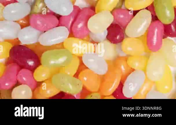 Colorful small jelly candies moving randomly in stop motion. . Seamless ...