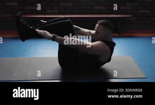 A man doing crunches exercise exercise pumping his abs muscles in the ...