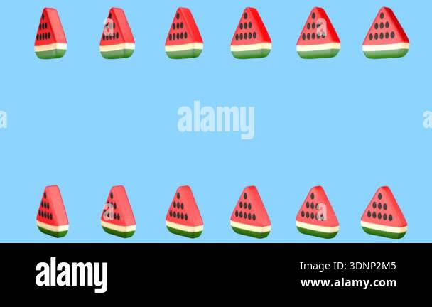 Pieces of watermelon are spinning on a blue background, with space for ...