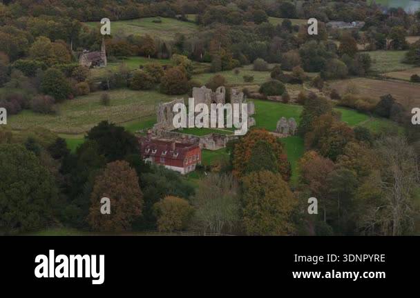 Scenic aerial footage showing the historic ruins of bayham old abbey, a ...
