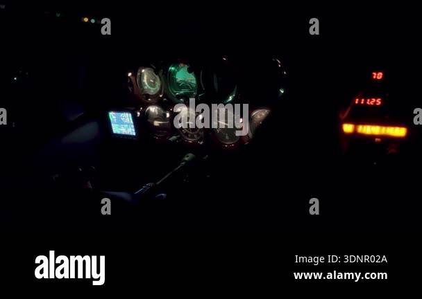 Airplane cockpit view shows illuminated dashboard with various gauges ...