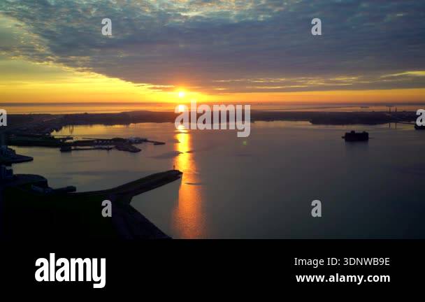 Aerial view on sunrise over sea shore, calm water, ports and city Stock ...