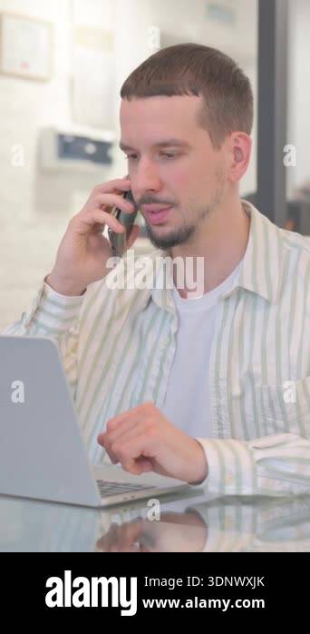 Creative Young Man Talking on Phone at Work, vertical video Stock Video ...