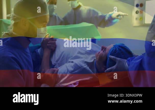 Medical staff wheeling patient into OR on gurney, draping sheet ...