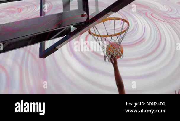Adult male arm raising basketball toward hoop, ball contacting rim and ...