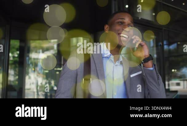 Businessman stepping out office, laughing on phone call, hanging up ...