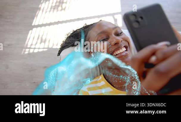 Woman tapping phone screen wearing earbuds, generating blue data wave ...