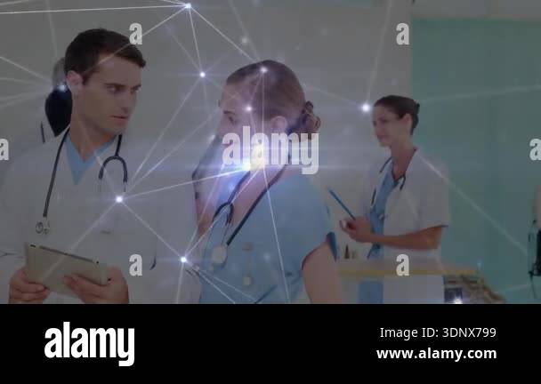 Male doctor tapping tablet and driving medical network overlay while ...