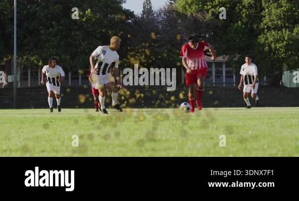 Football attacker dribbling ball down center pitch evading defender ...