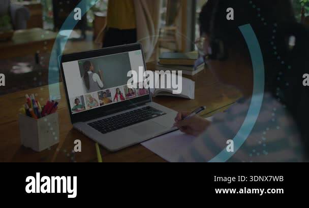Schoolgirl opening laptop joining remote class while taking notes with ...