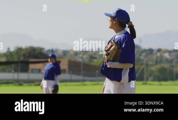 Lifting gaze skyward baseball pitcher crouching on mound generating ...