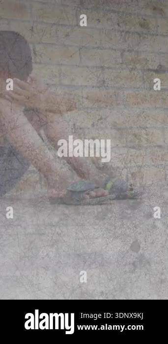 Animation of cracked texture changing over sad boy sitting on pavement ...