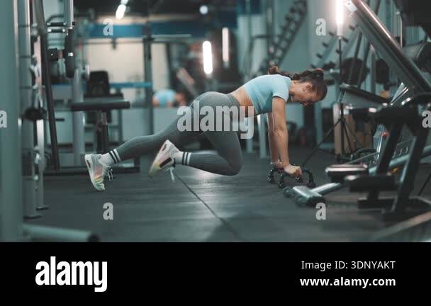 Athletic woman doing intense core workout with mountain climbers in a ...