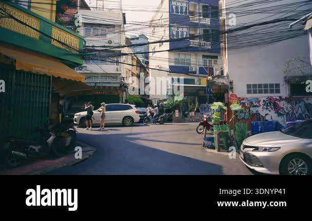 Bangkok urban alleyway showcasing tangled electrical wiring, street art ...