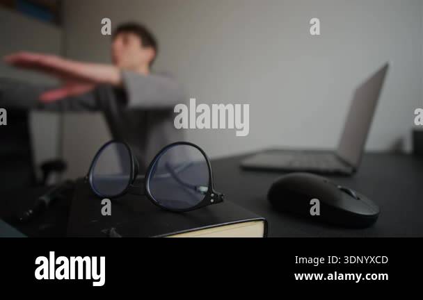 Healthy work break concept, office desk in focus with blurred man doing ...