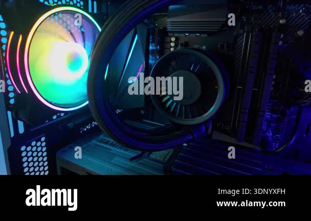 Slow motion pan across gaming pc interior with rgb lighting, liquid ...