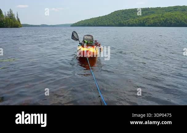 Fully rigged kayak watercraft mooring and tied to boat pier near ...