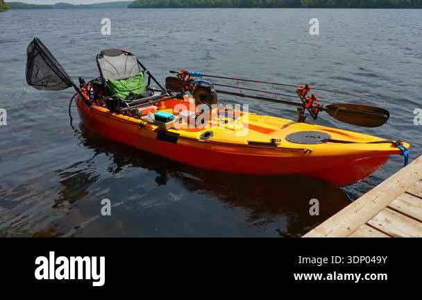 Fully rigged kayak watercraft mooring and tied to boat pier near ...