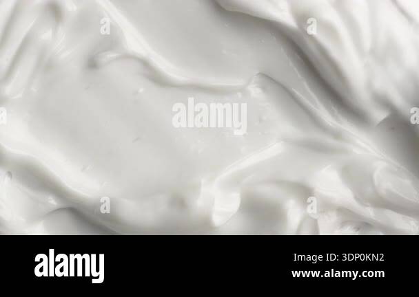 Slow motion of facial cream, ice-cream or yogurt mixture stirring ...