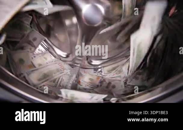 US cash spinning inside a washing machine in slow motion wide angle ...