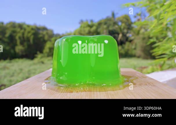 Close Up Shot of Green Jelly Deforming and Shaking After Repeated Spoon ...