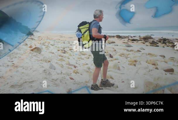 Mature hiker surveying ocean planting poles and rock-hopping with map ...