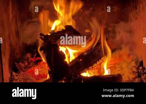 Strong fire consuming wooden logs inside fireplace, vivid flame and ...