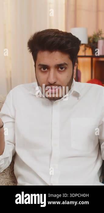 Indian man at home looking surprised, raising hands in a what why ...