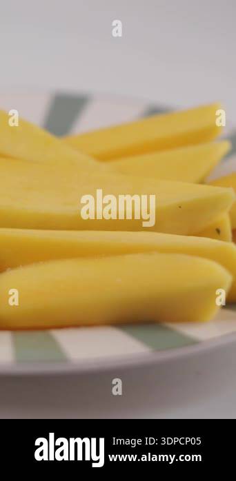 Fresh mango slices are placed on a plate. They look ready to eat Stock ...