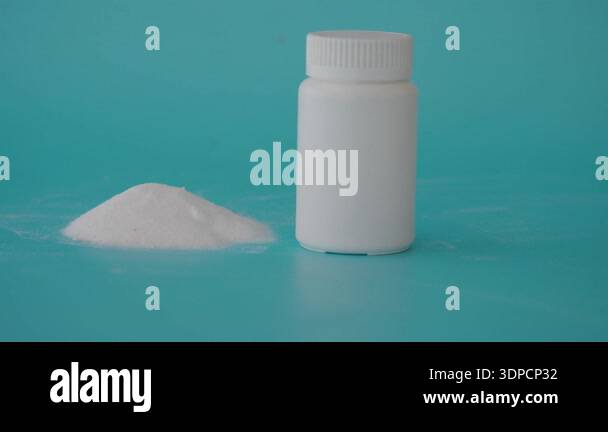 White Powder and Medicine Bottle on a Blue Background Stock Video ...