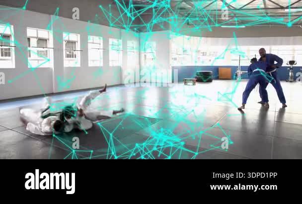 Training partners gripping gis in dojo breaking balance and executing ...