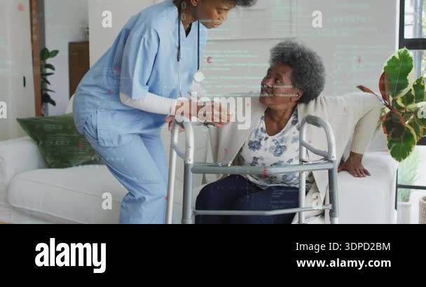 Nurse placing hand on patient shoulder and guiding standing transfer ...