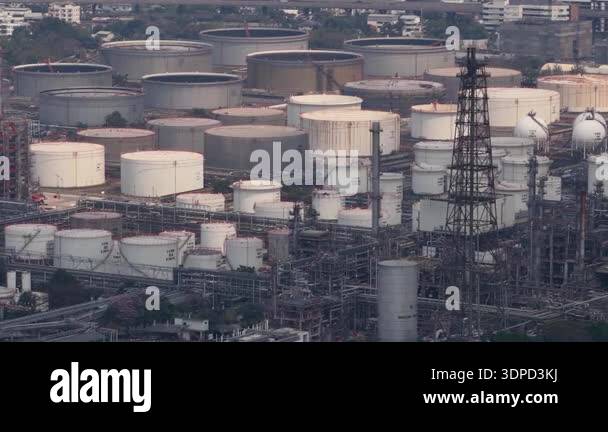 Expansive aerial view of a massive oil refinery with rows of storage ...