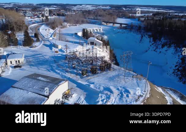 Aerial drone view of a rural hydroelectric power station with its dam ...