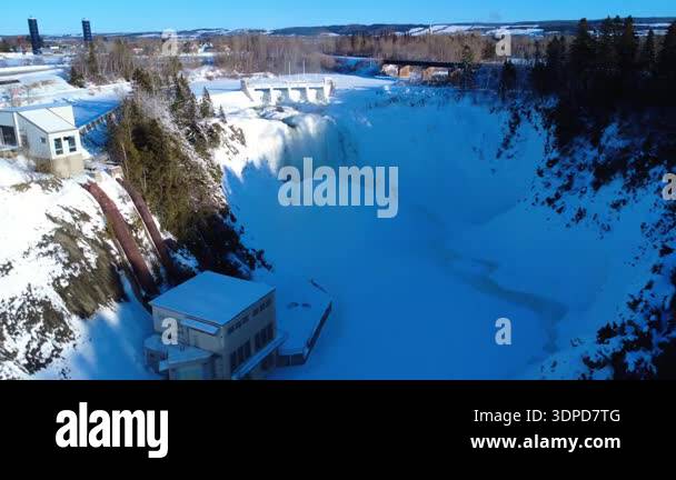 A hydroelectric dam site with all its infrastructure and buildings near ...