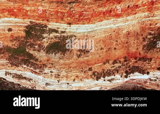 Rock formations show distinct layers of sediment and minerals on a ...