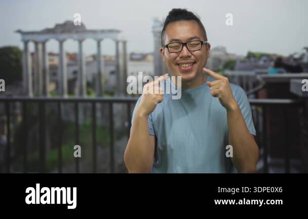Man pointing finger to face at roman ruins building balcony, smiling ...