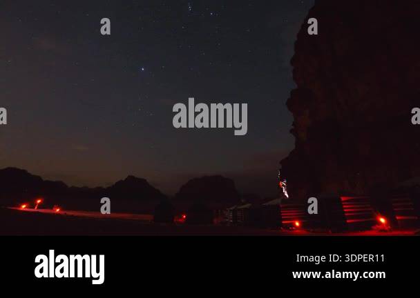 Time lapse Bedouin desert camp glowing with red lights under star ...