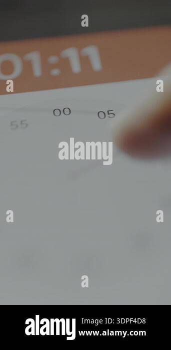 Finger setting the exact time on the digital clock for the upcoming ...