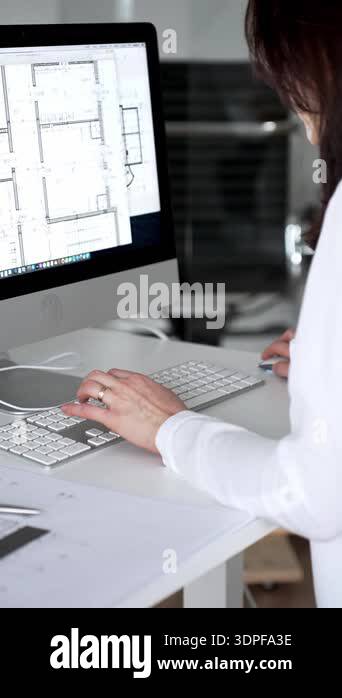 Professional architect woman typing on computer keyboard, overseeing ...