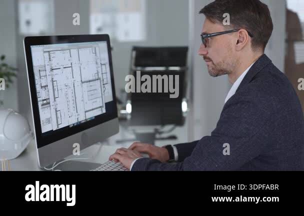Engineer designing a modern building floor plan on cad software at a ...