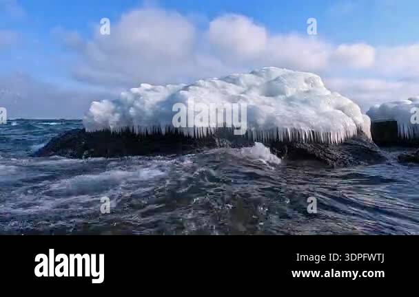 Winter coastline of the Black Sea, ice icicles and blue ice formations ...