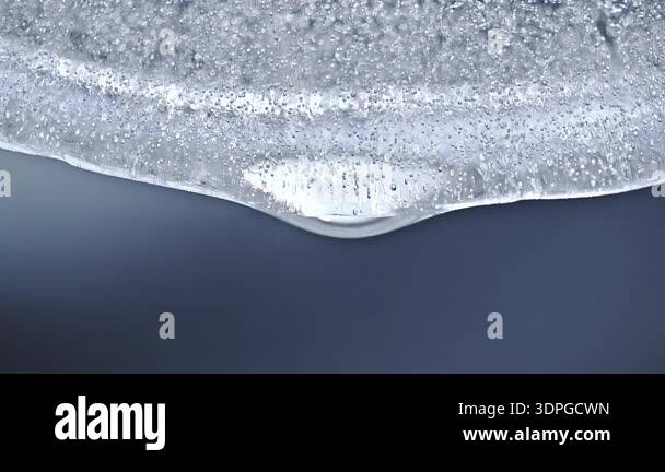 Melting ice block with water drops falling down in slow motion Stock ...