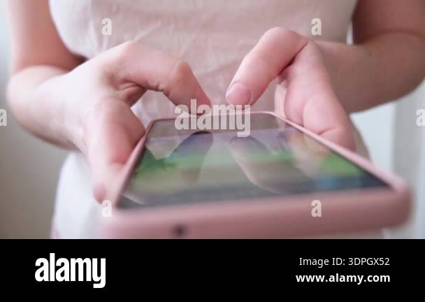 Woman hand holding cell phone touch screen typing scroll page using app ...