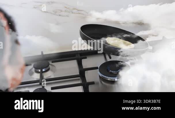 Home cook removing pancake from gas stove for eating, cloud overlay ...