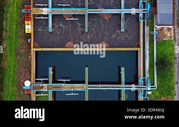 Aerial top down view of industrial sewage treatment tanks. Geometric ...