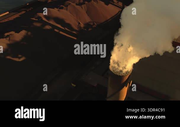 Industrial smokestack releasing thick toxic coal smoke at sunset ...