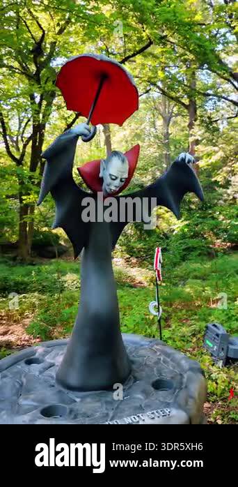 New York, USA, 17 August 2025: Vampire sculpture with red umbrella in ...